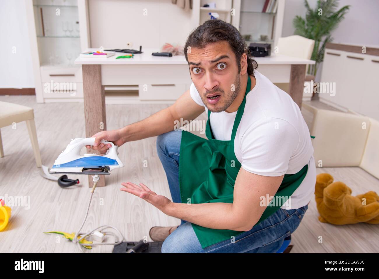 Young contractor cleaning the flat after kids' party Stock Photo - Alamy