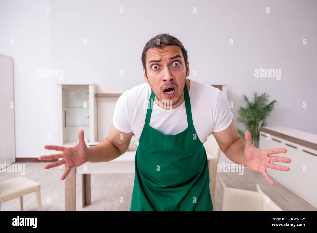 Young contractor cleaning the flat after kids' party Stock Photo - Alamy