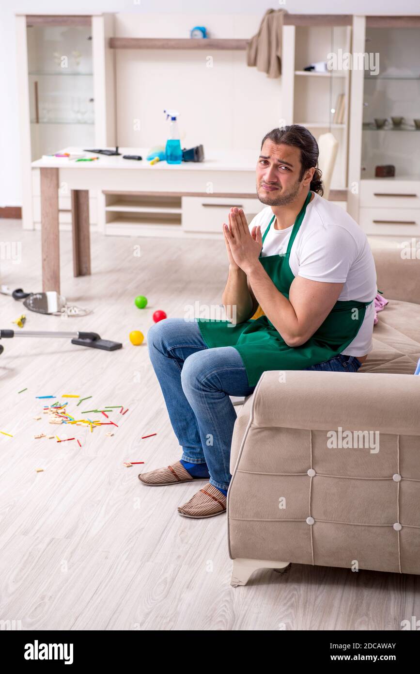 Young contractor cleaning the flat after kids' party Stock Photo - Alamy