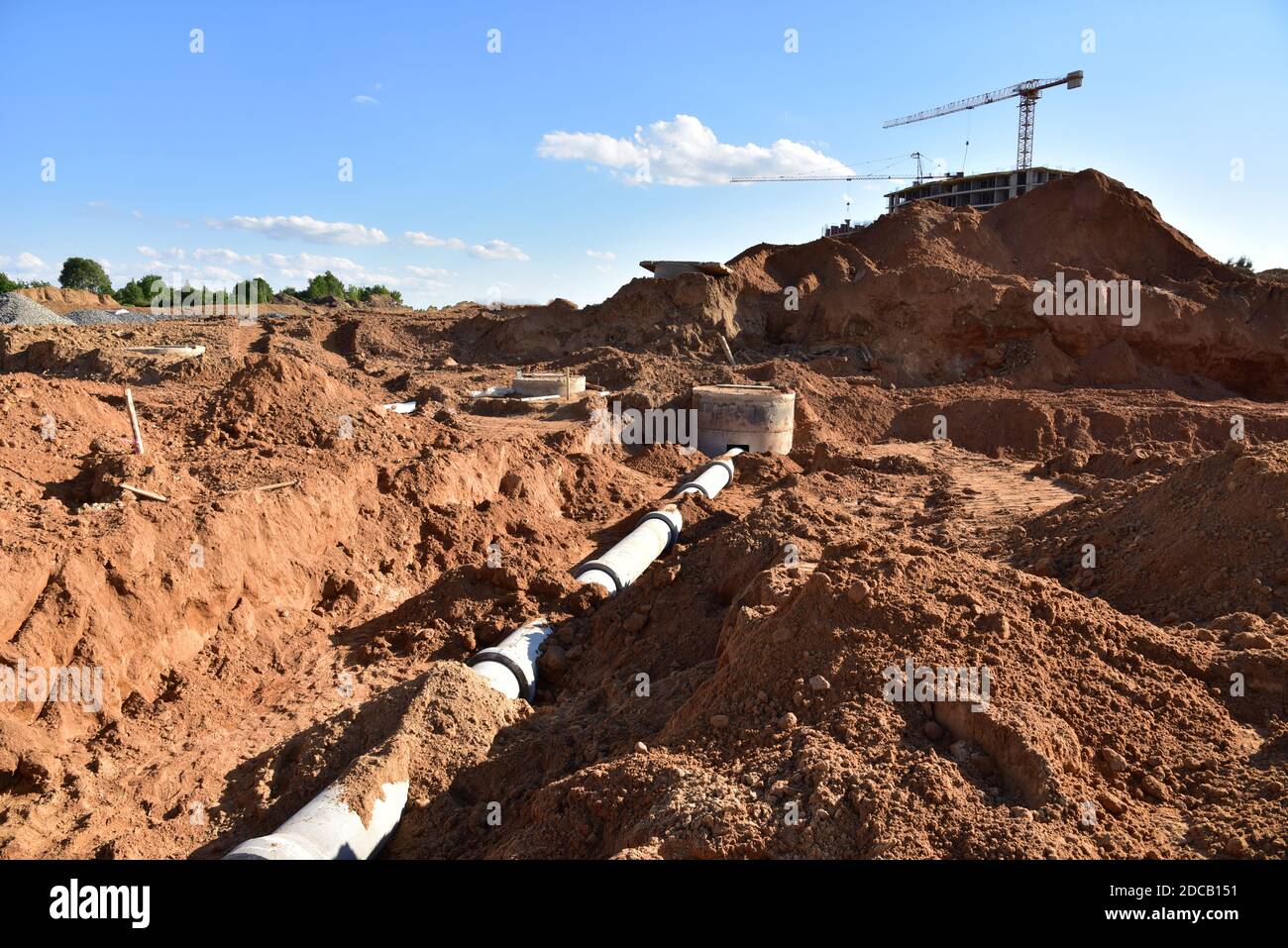 Laying concrete manholes and drain pipes for stormwater system ...