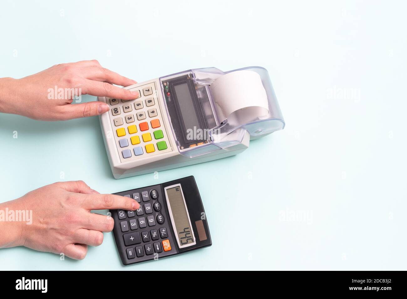 Close-up of a female hand pressing a finger on a cash register button ...