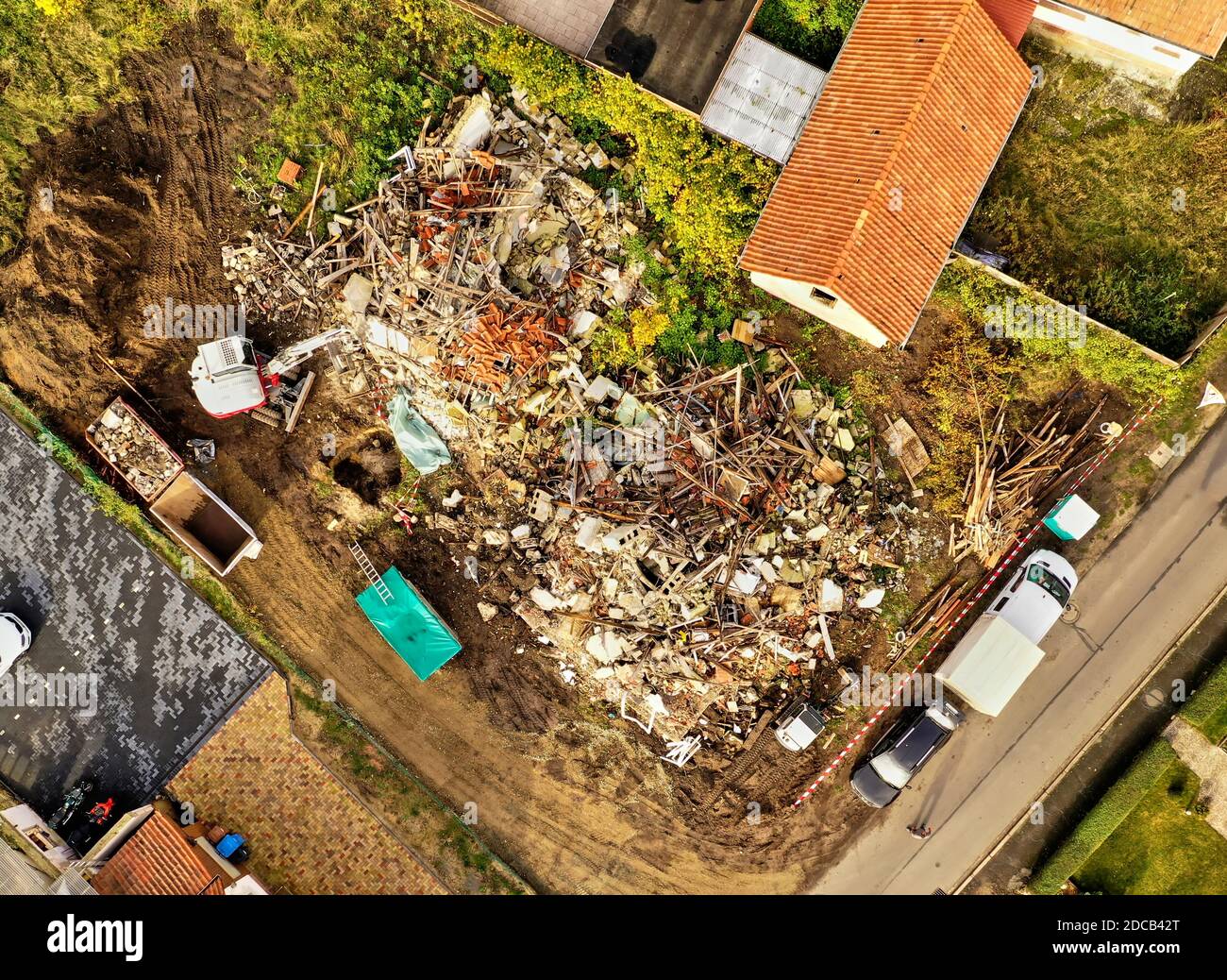 Vertical aerial view of a completely demolished house with the rubble ...