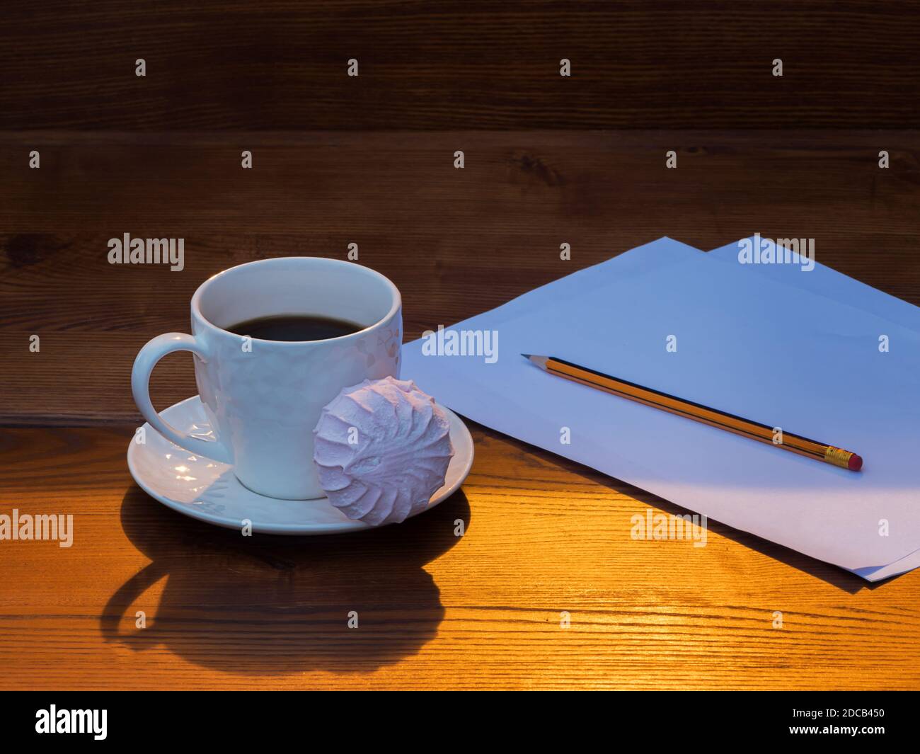 White cup of coffee and pink zefir on the wooden background ...