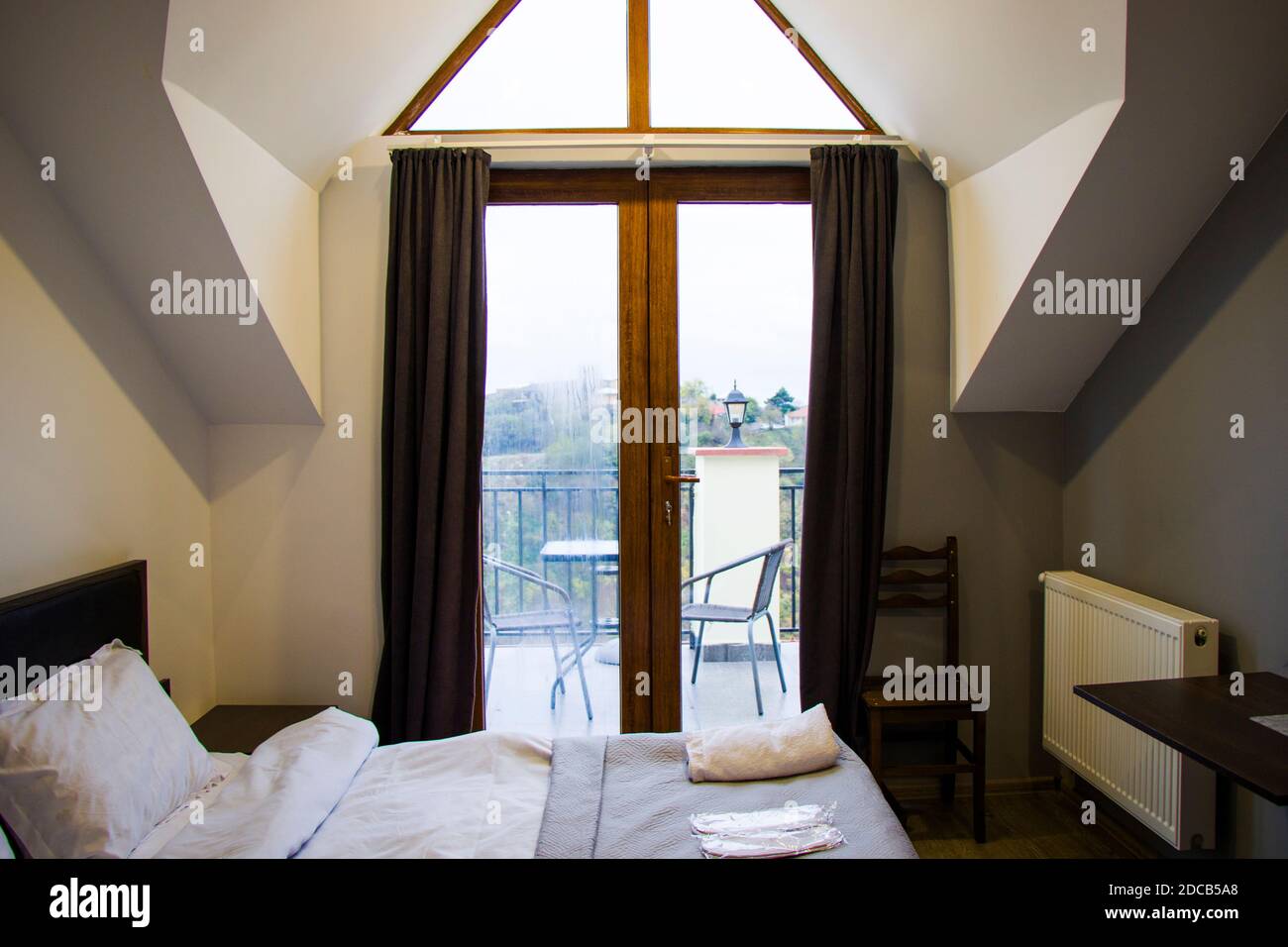 Guest house and hostel room interior, bed and table Stock Photo - Alamy