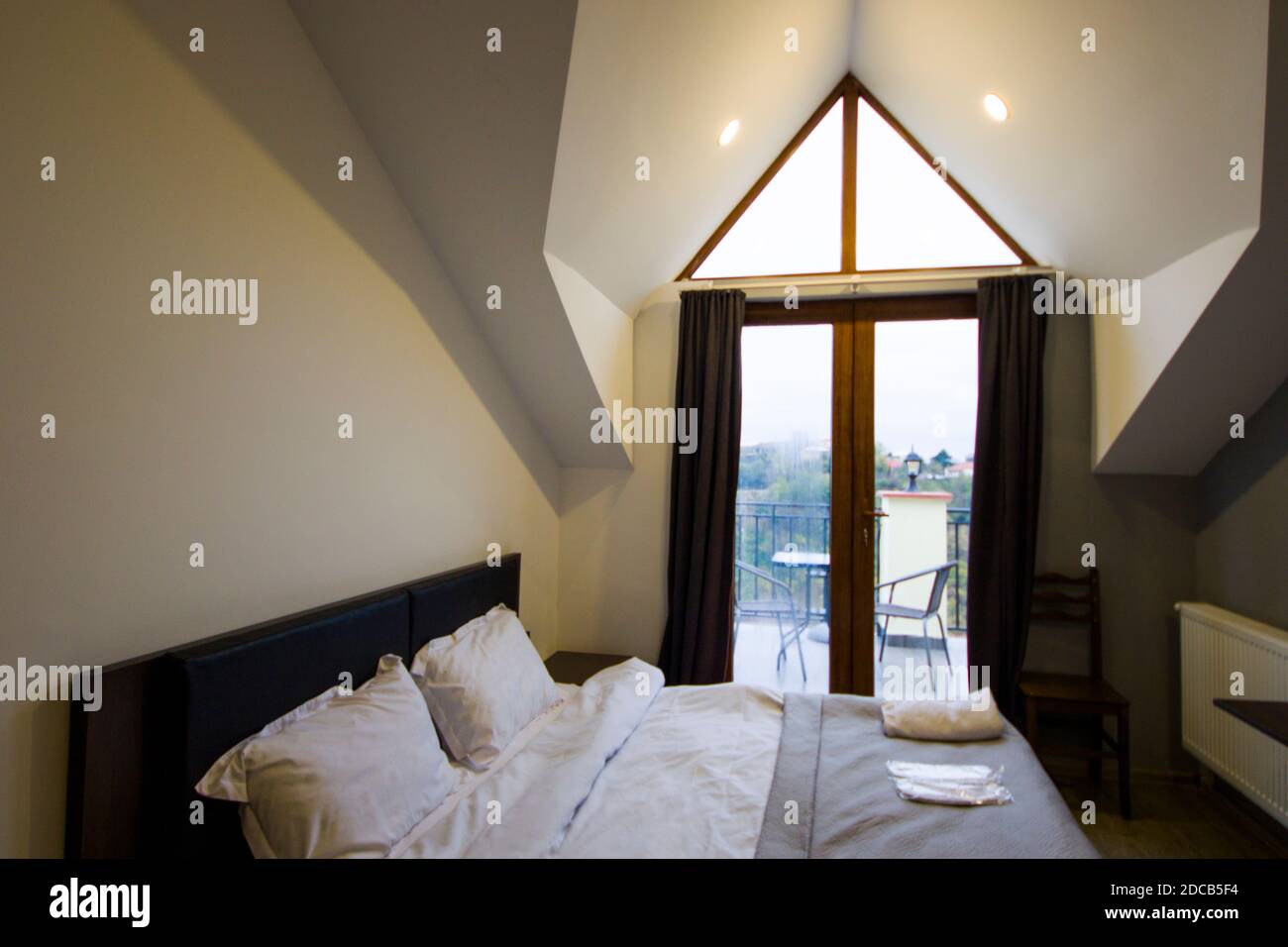 Guest house and hostel room interior, bed and table Stock Photo - Alamy
