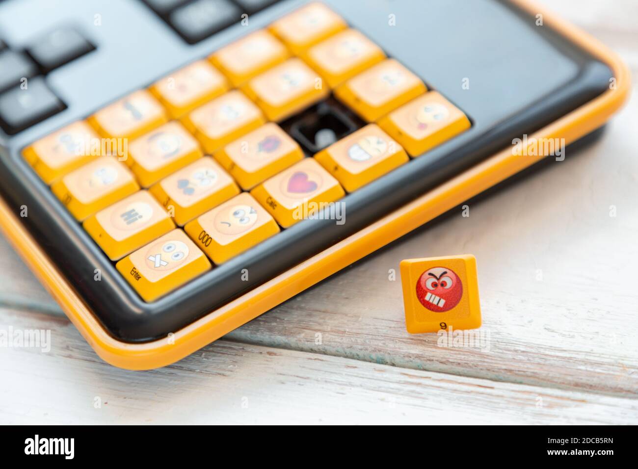 Button with an angry emoticon on the keyboard background. Concept of ...