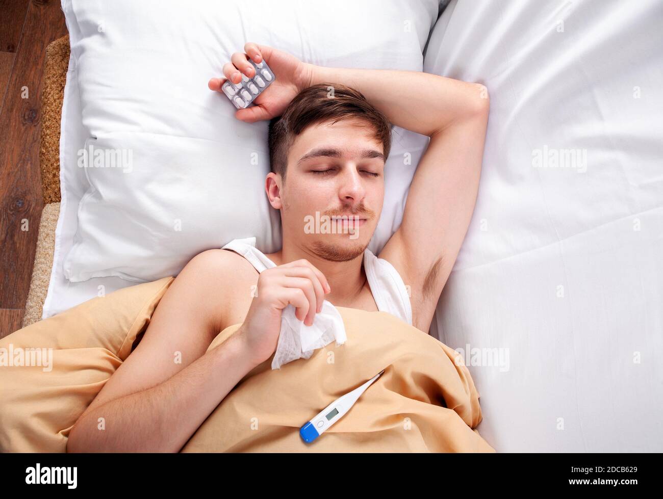 Sick Young Man sleep in the Bed at the Home Stock Photo - Alamy