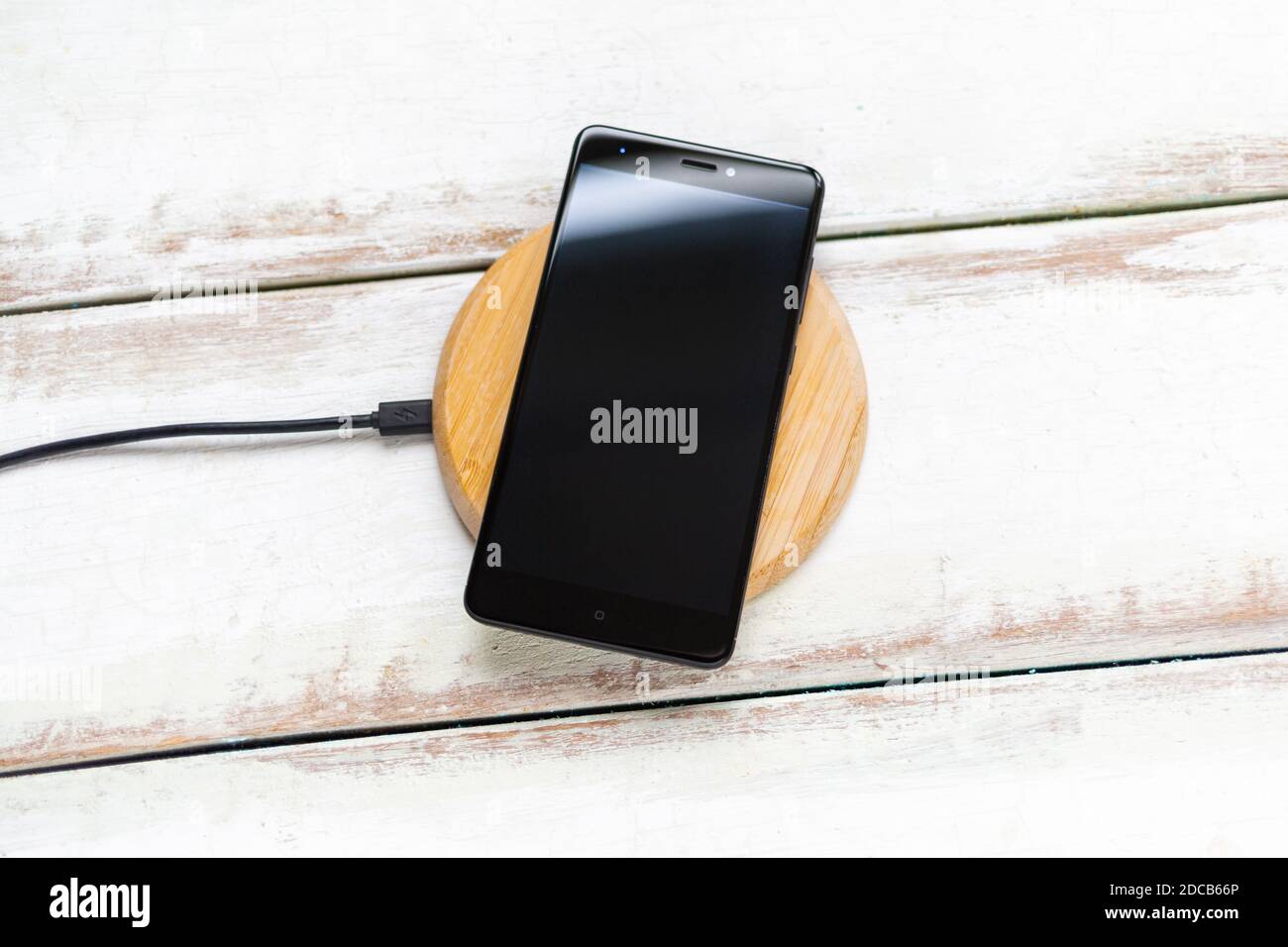 Concept of modern technologies. The black smartphone is on a wireless ...