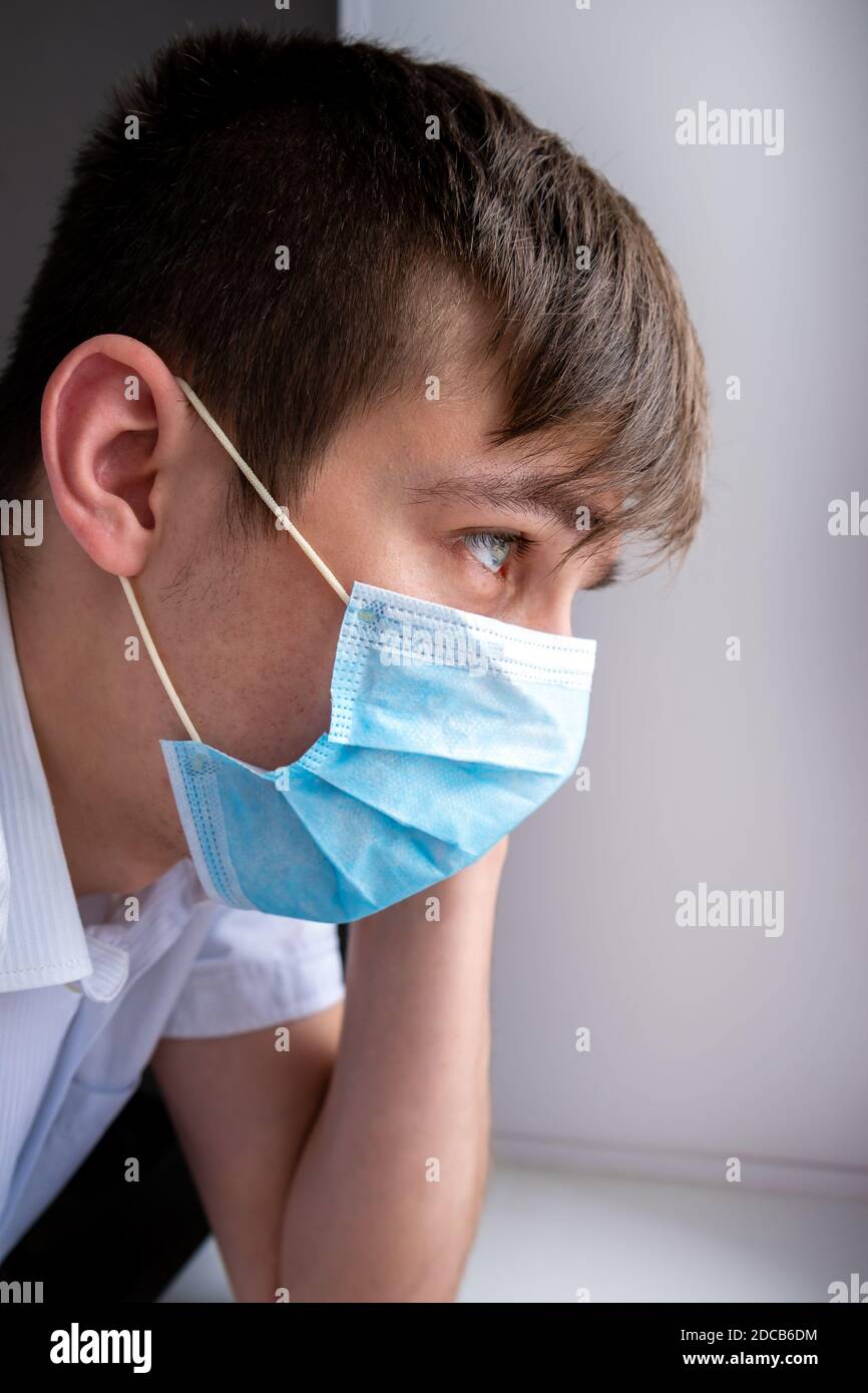 Portrait of Young Man in a Flu Mask by the Wall in the Room Stock Photo ...