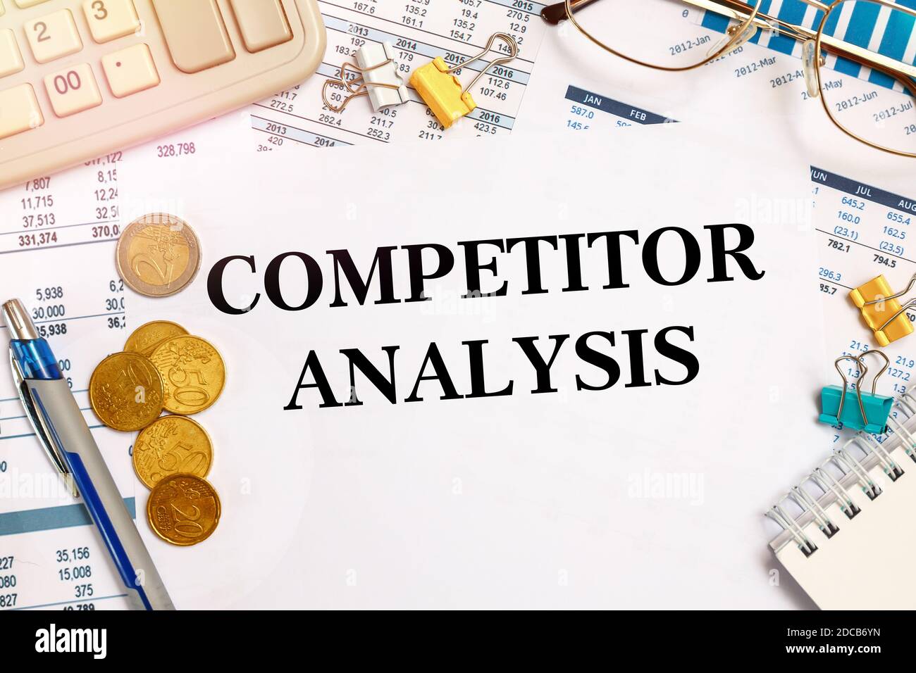 Paper with the text COMPETITOR ANALYSIS on the office table among the ...