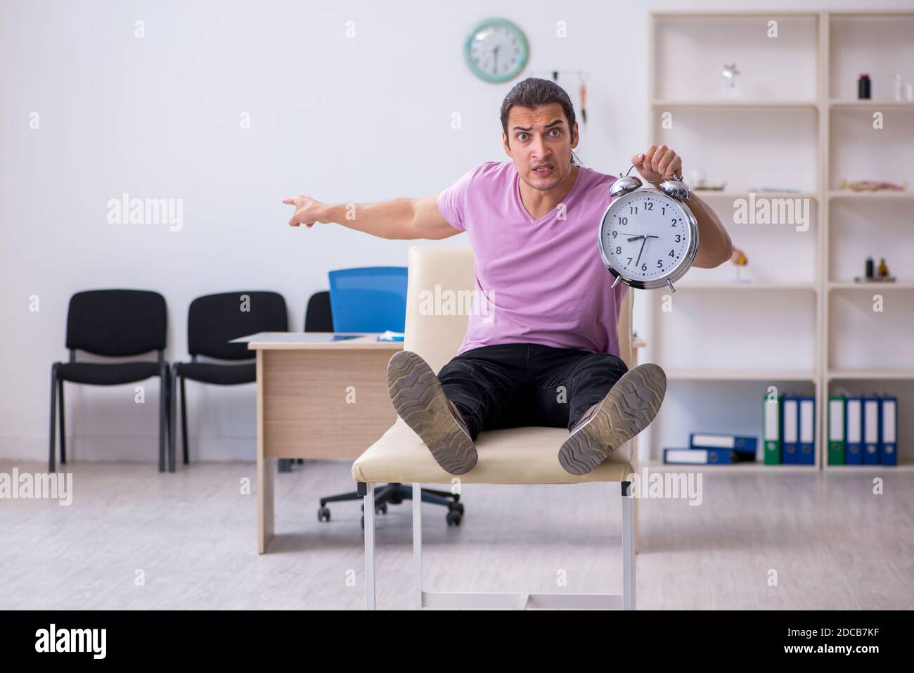 Male patient waiting for doctor in time management concept Stock Photo ...