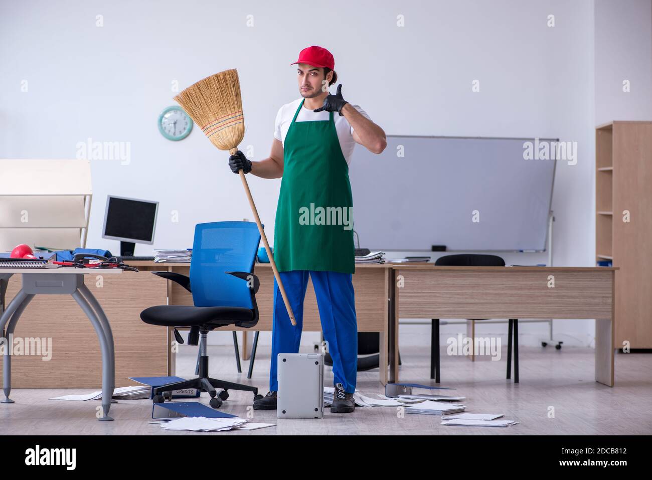 Young contractor cleaning the office Stock Photo - Alamy