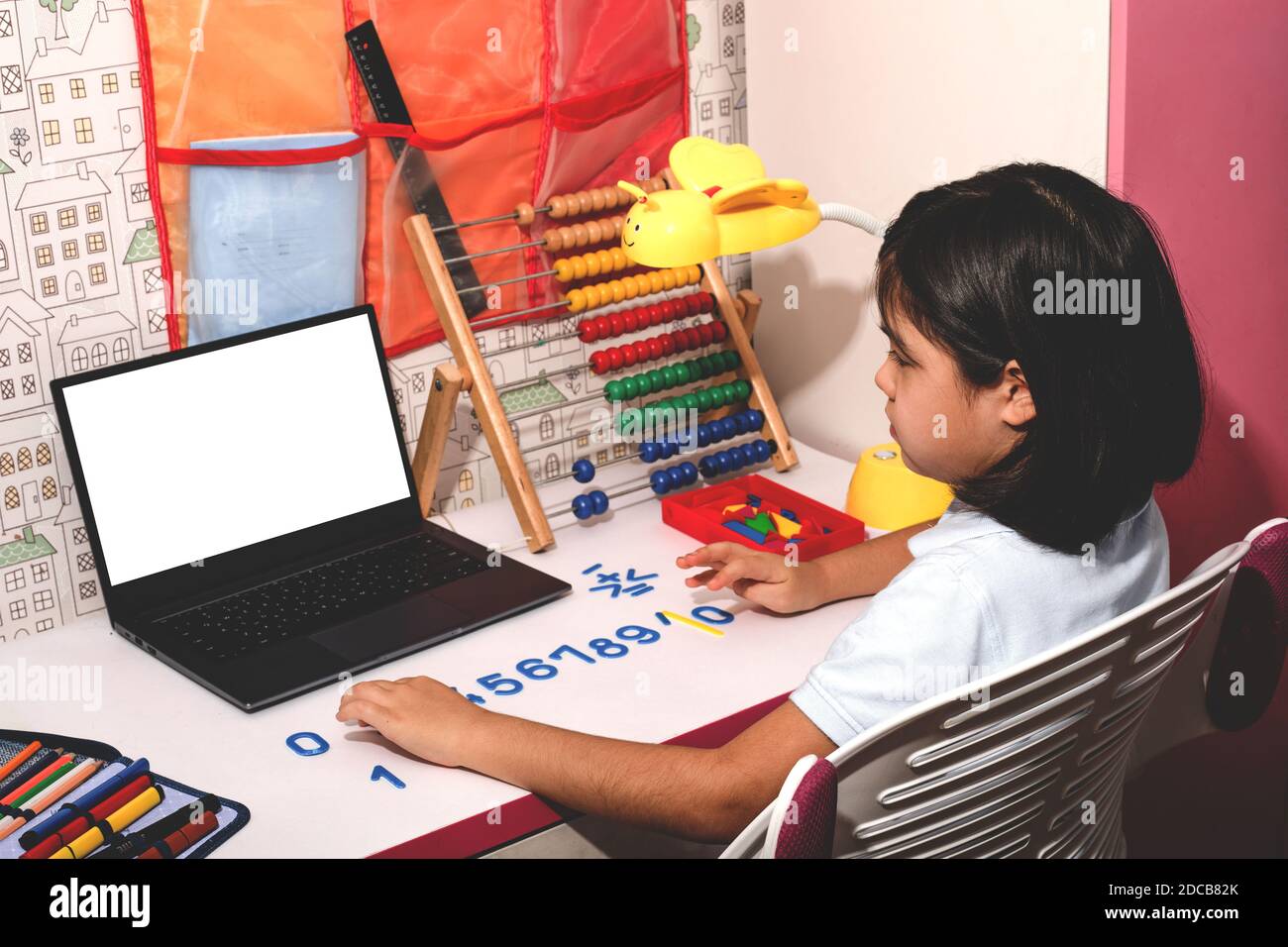 Asian schoolgirl studying homework math during her online lesson at ...