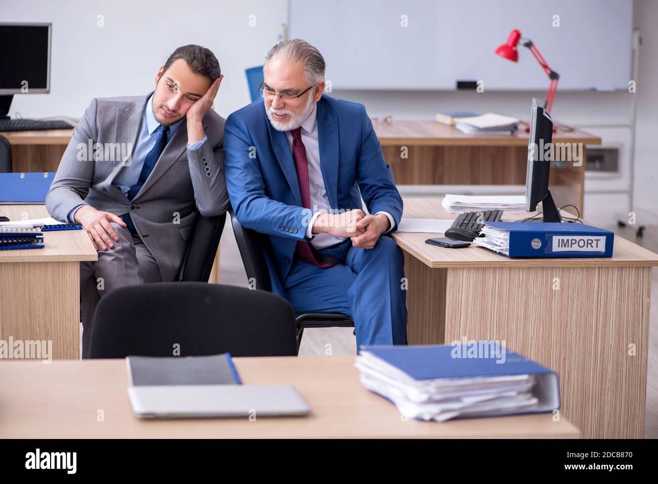 Two employees working in the office Stock Photo - Alamy