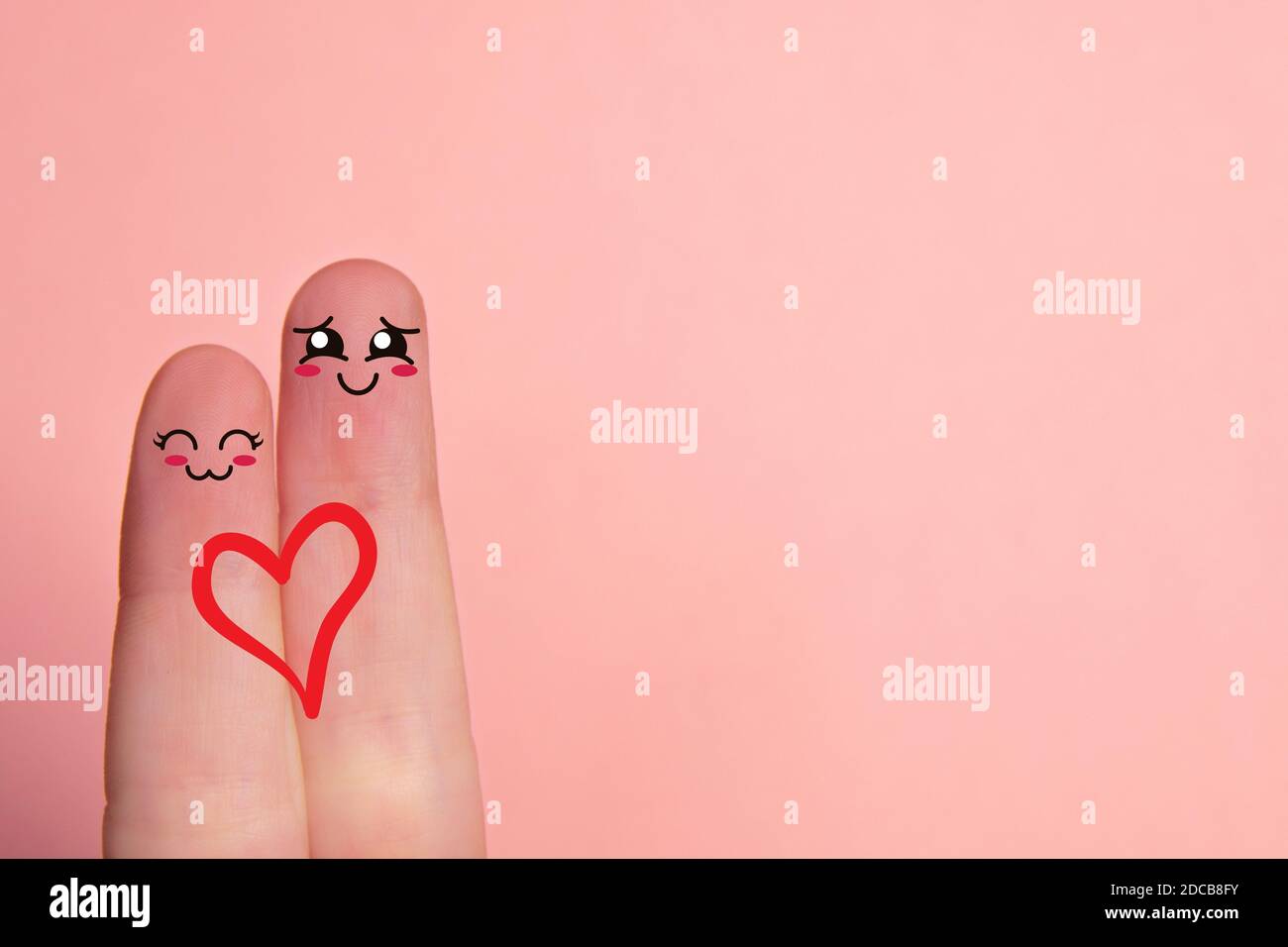 Fingers of love. Close-up of two fingers on pink background with drawn ...