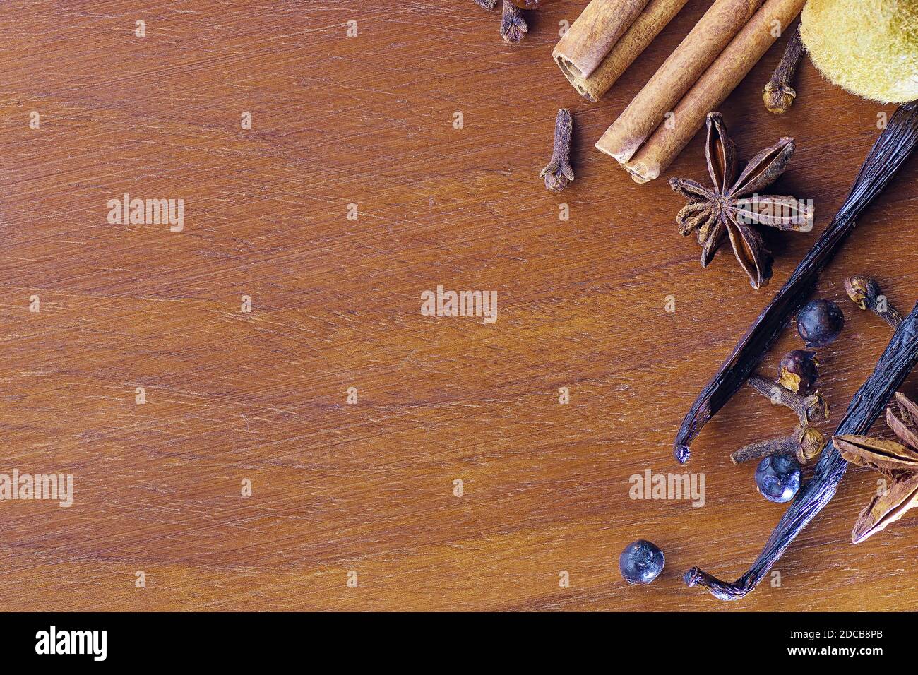 Walnut wooden board laden with Christmas spices, cinnamon, star anise ...