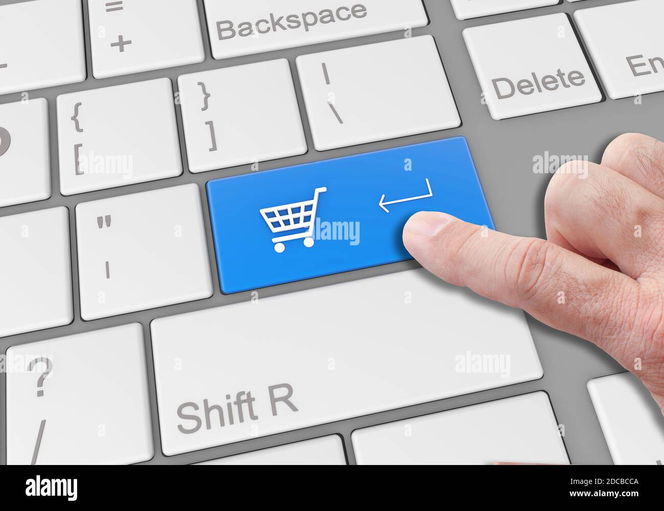 A person clicking a special "shopping cart" button on a laptop keyboard ...
