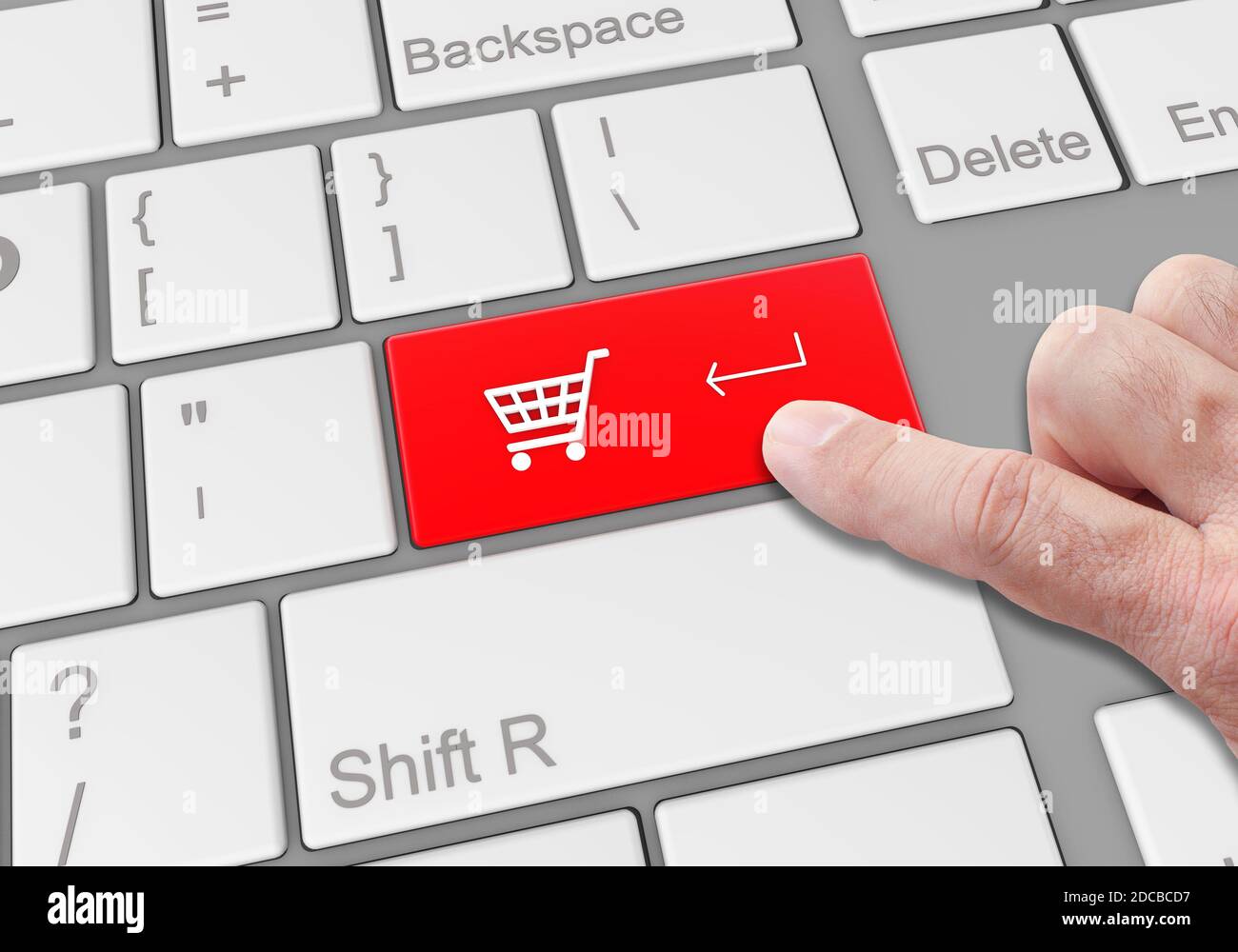 A person clicking a special "shopping cart" button on a laptop keyboard ...