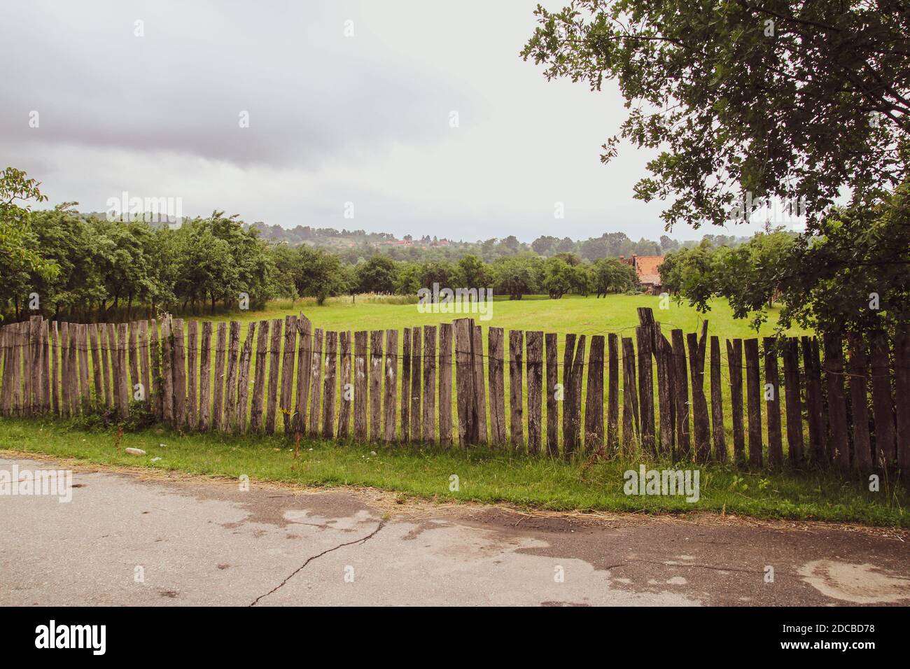 Countryside road and wooden fence Stock Photo - Alamy