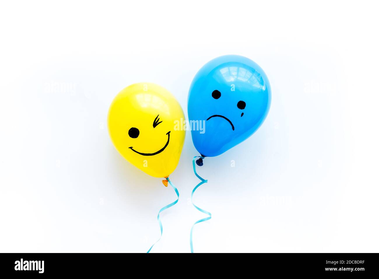 Emotions concept. Happiness and depression faces on balloons, top view ...