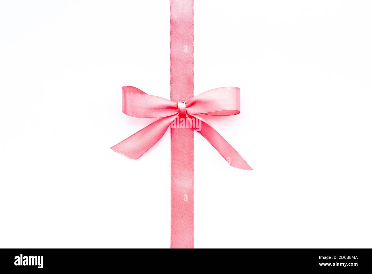 Pink ribbon with bow isolated on white. Top view, copy space Stock ...