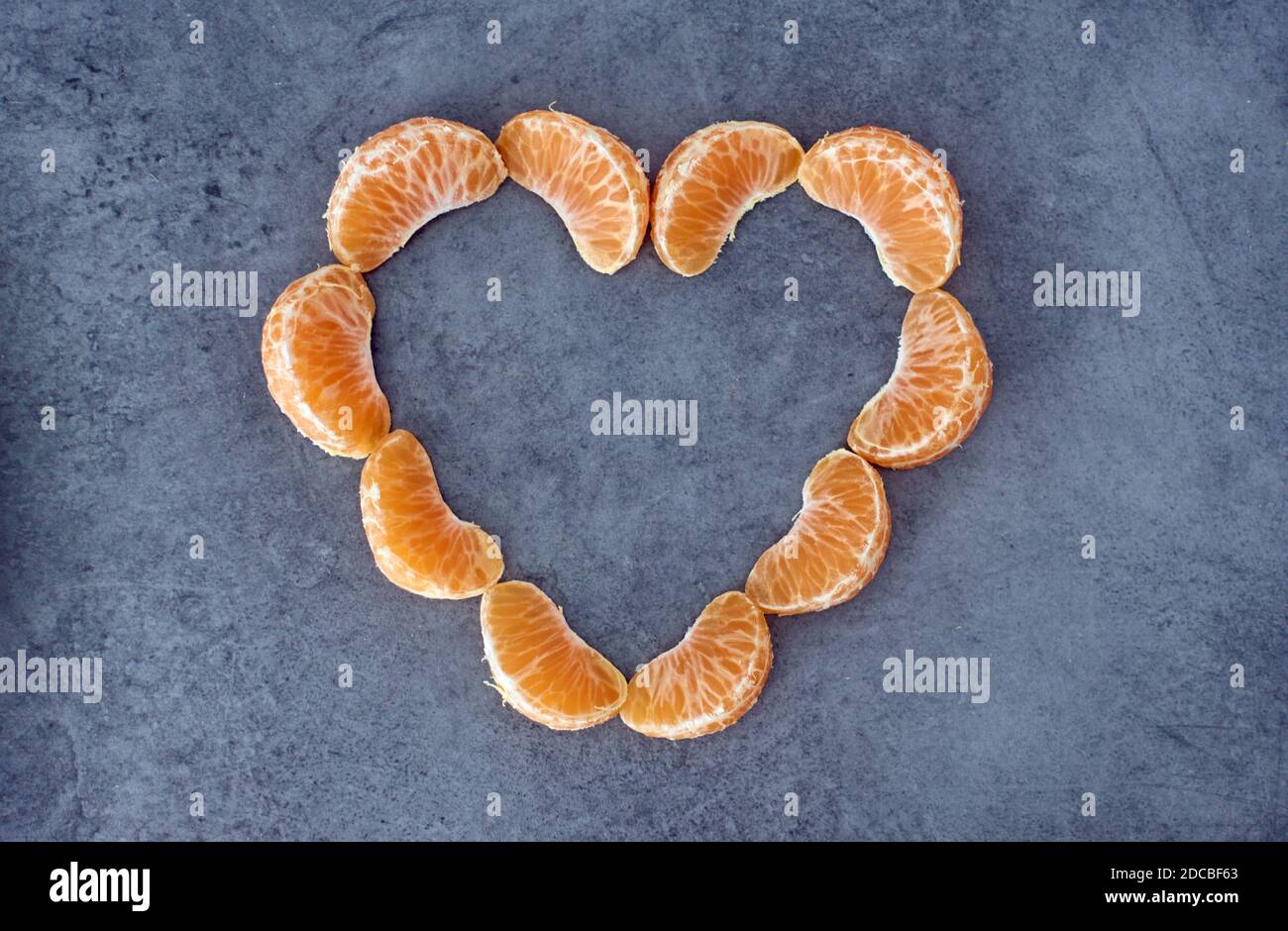 A high angle shot of tangerine pieces shaped like a heart Stock Photo ...
