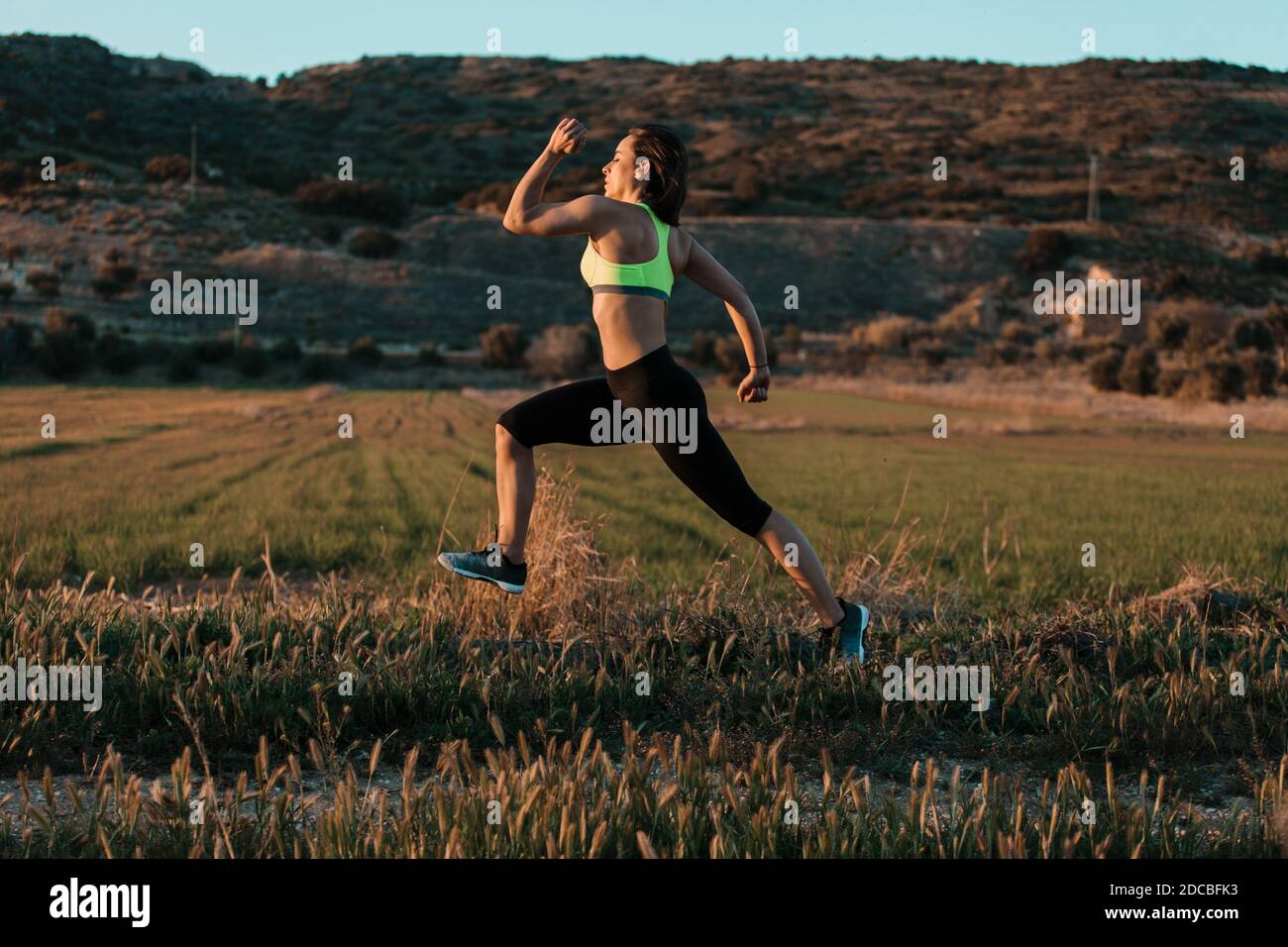 Young woman jogging through countryside hi-res stock photography and ...