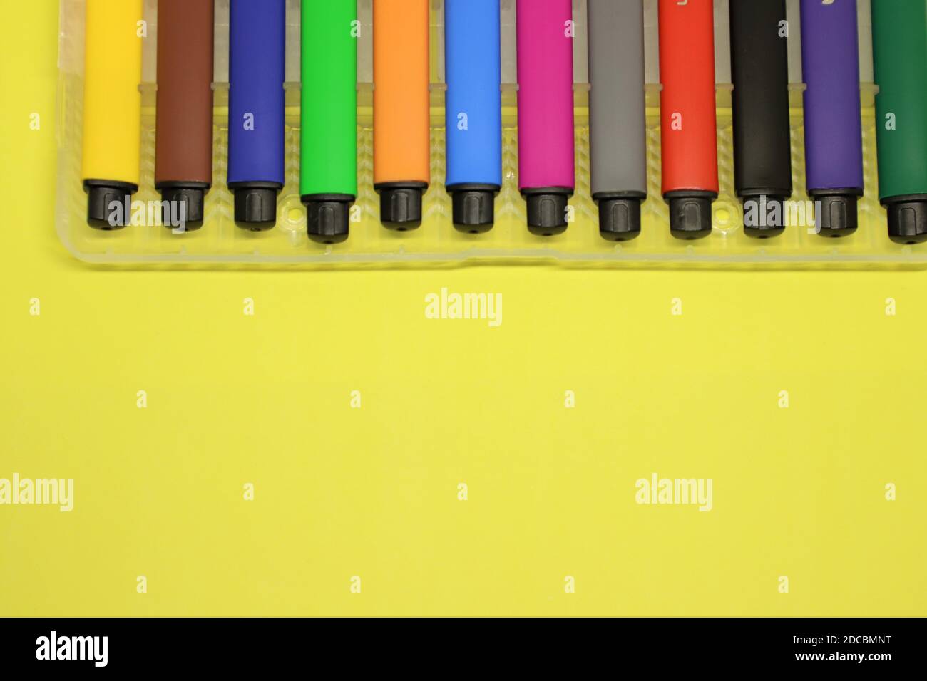 Marker drawing colorful pens inside box isolated on yellow background ...