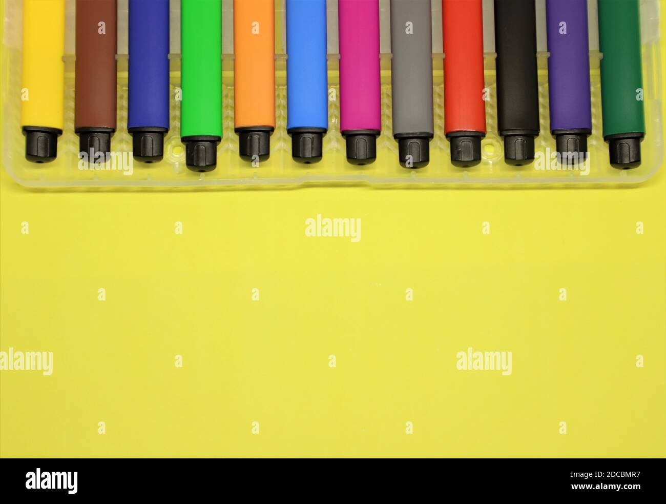 Marker drawing colorful pens inside box isolated on yellow background ...