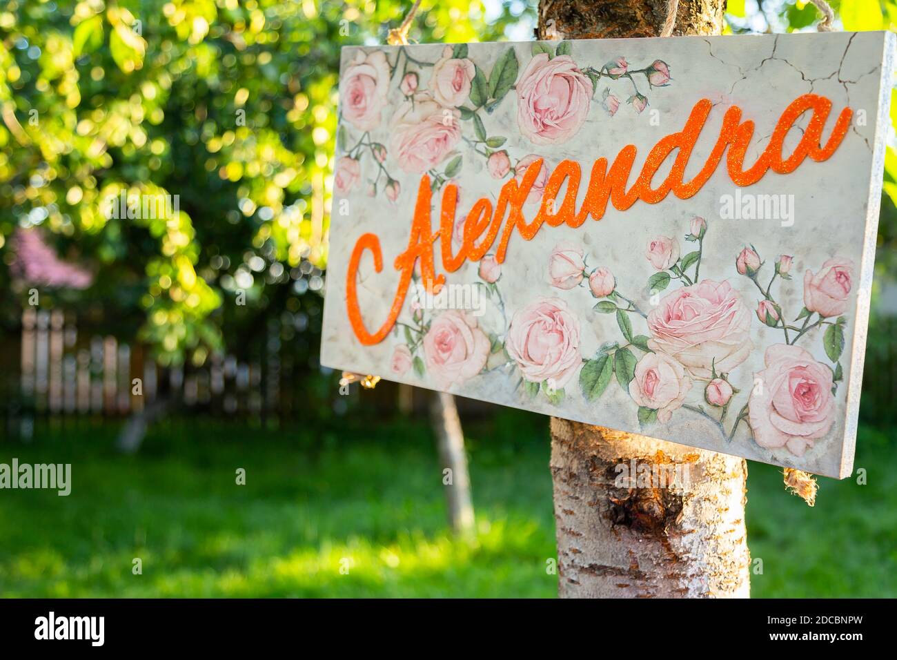 A closeup shot of a floral birthday sign with a female name of ...