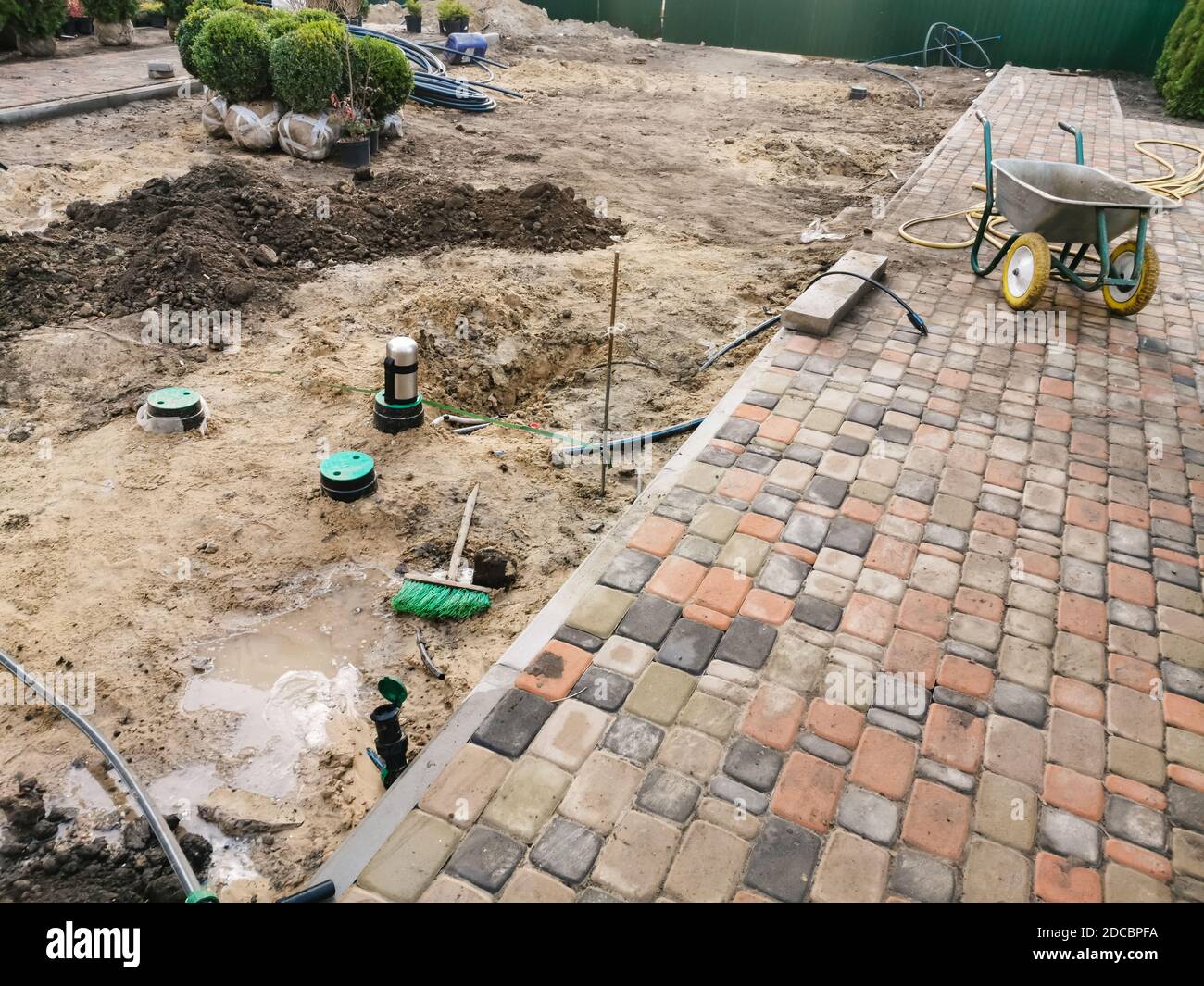 industrial worker installing pavement rocks, cobblestone blocks on road ...