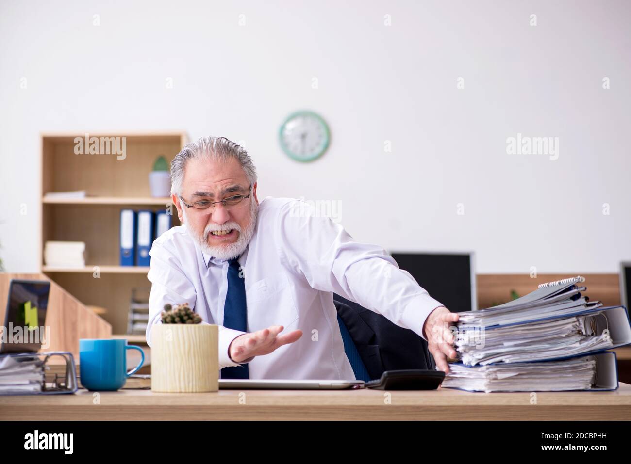 Old employee working in the office Stock Photo - Alamy