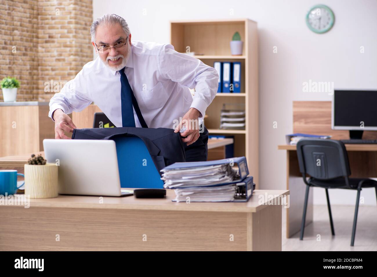 Old employee working in the office Stock Photo - Alamy