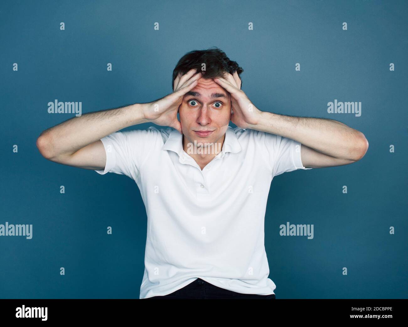 young goofy man with pimples pointing gesturing in studio, stupid ...