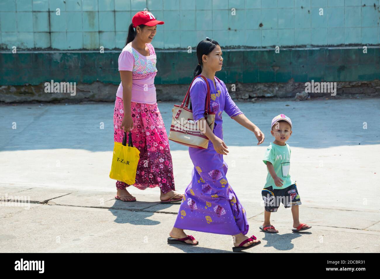 Daily life in Myanmar - women and young boy walking at Yangon, Myanmar ...