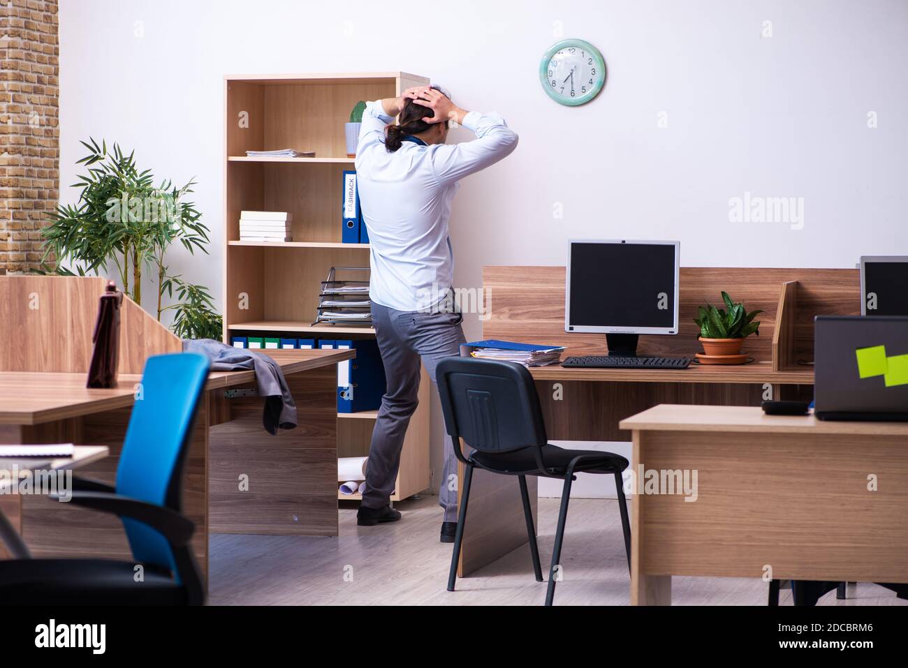 Male employee being late for his job Stock Photo - Alamy