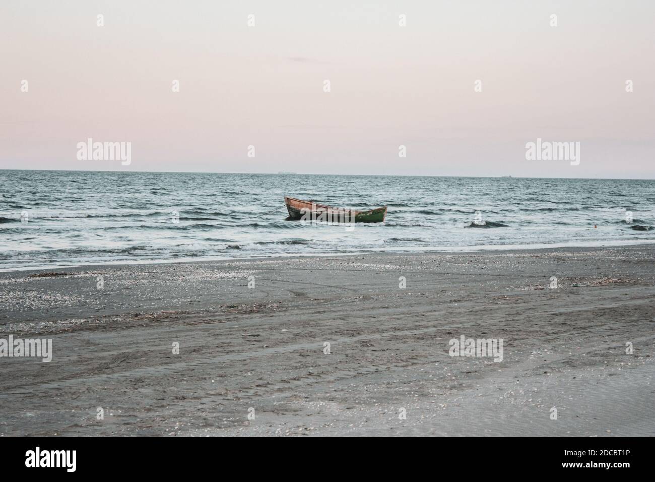 Isolated boat on the beach Stock Photo - Alamy