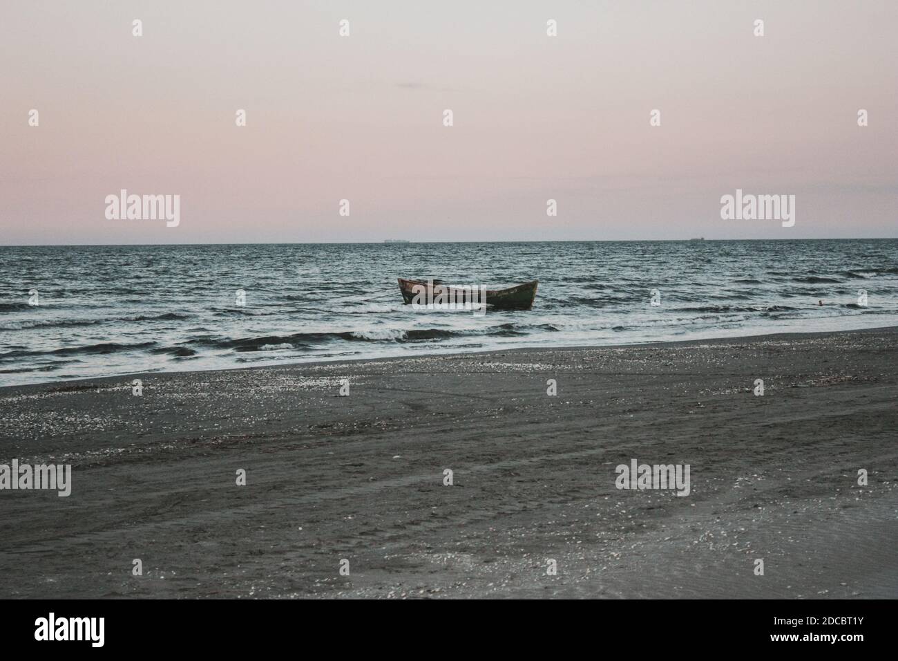 Isolated boat on the beach Stock Photo - Alamy
