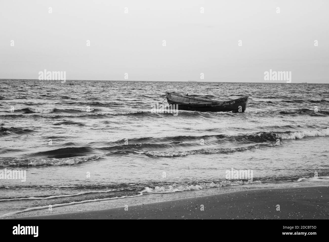 Isolated boat on the beach Stock Photo - Alamy