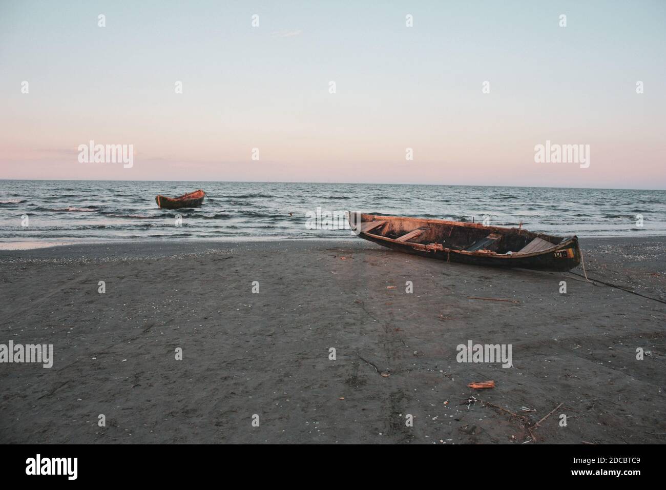 Isolated boat on the beach Stock Photo - Alamy
