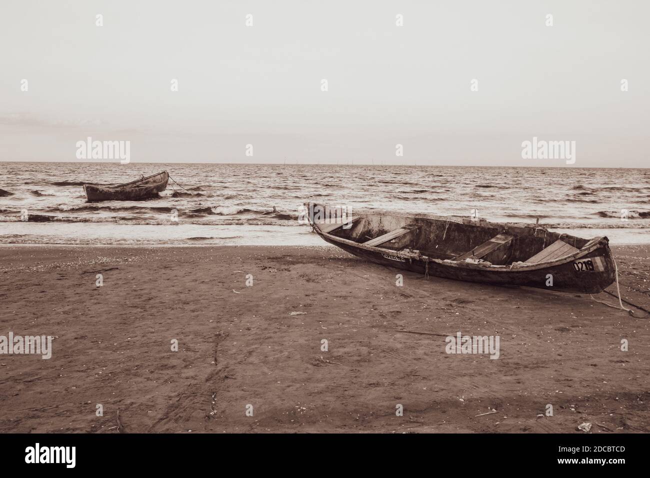 Isolated boat on the beach Stock Photo - Alamy