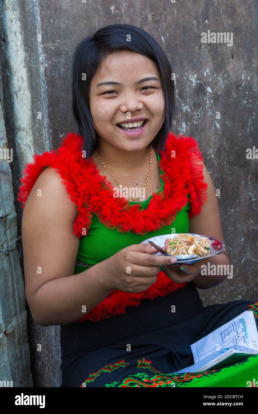 Daily life in Myanmar - happy young woman with food for lunch at Yangon ...
