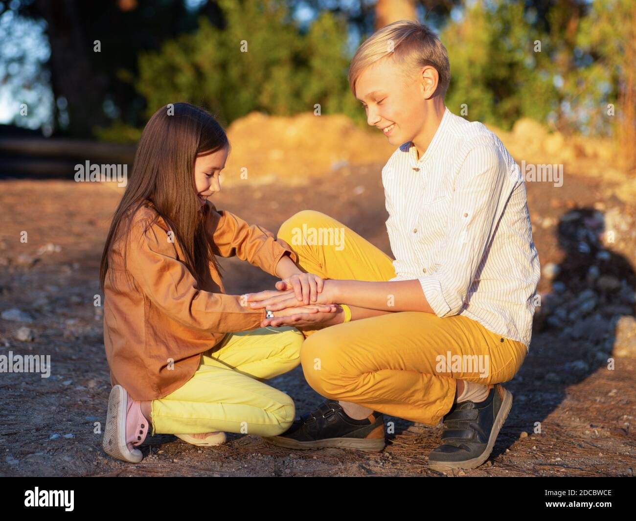 boy with girl clap in park in autumn Stock Photo - Alamy