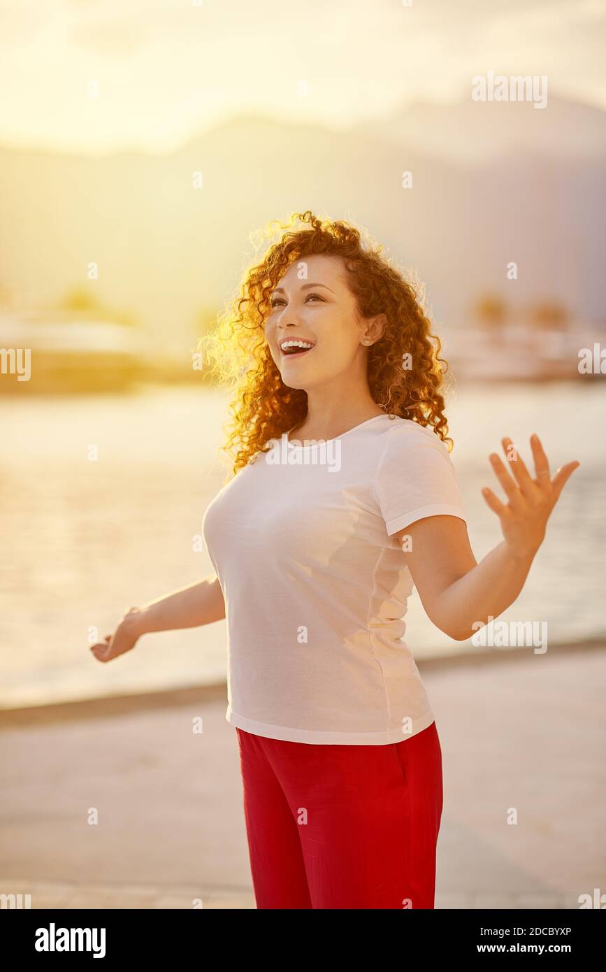 Woman singing on the beach Stock Photo - Alamy