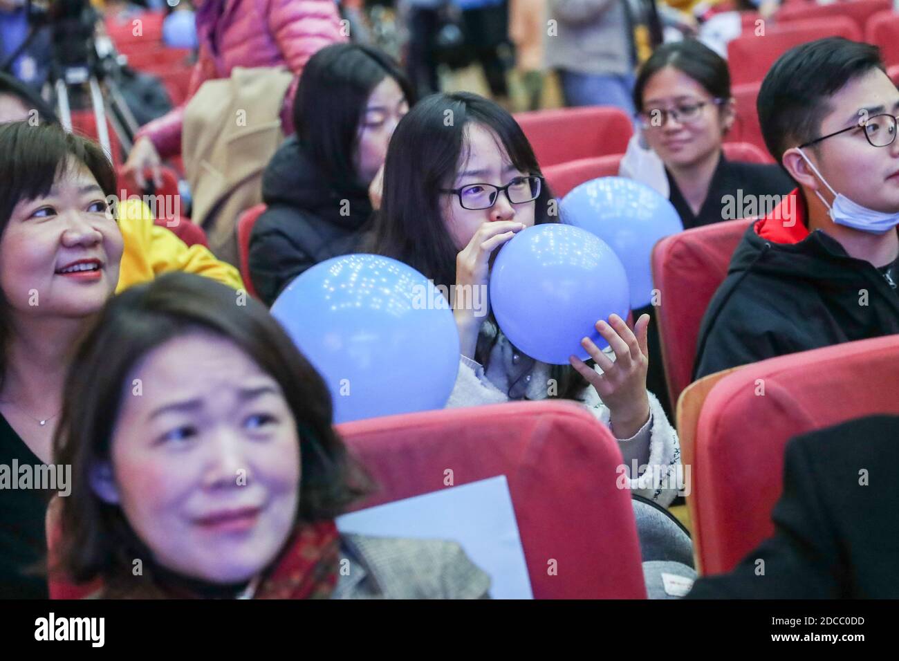 Beijing, China. 20th Nov, 2020. A spectator blows up a blue balloon at ...