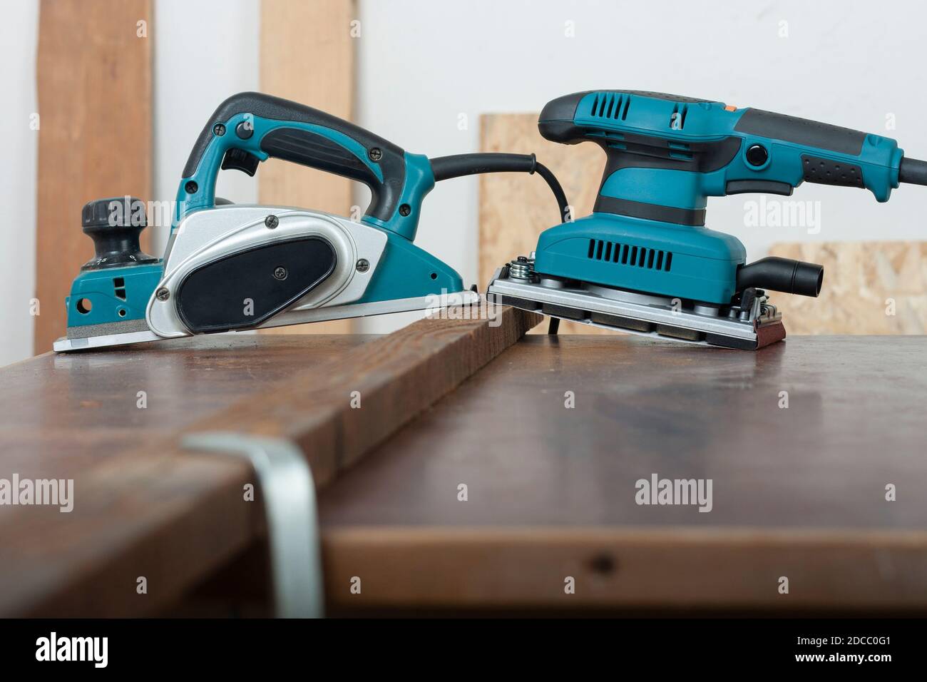 Electric planer and electric sheet finishing sander on wood lath on ...