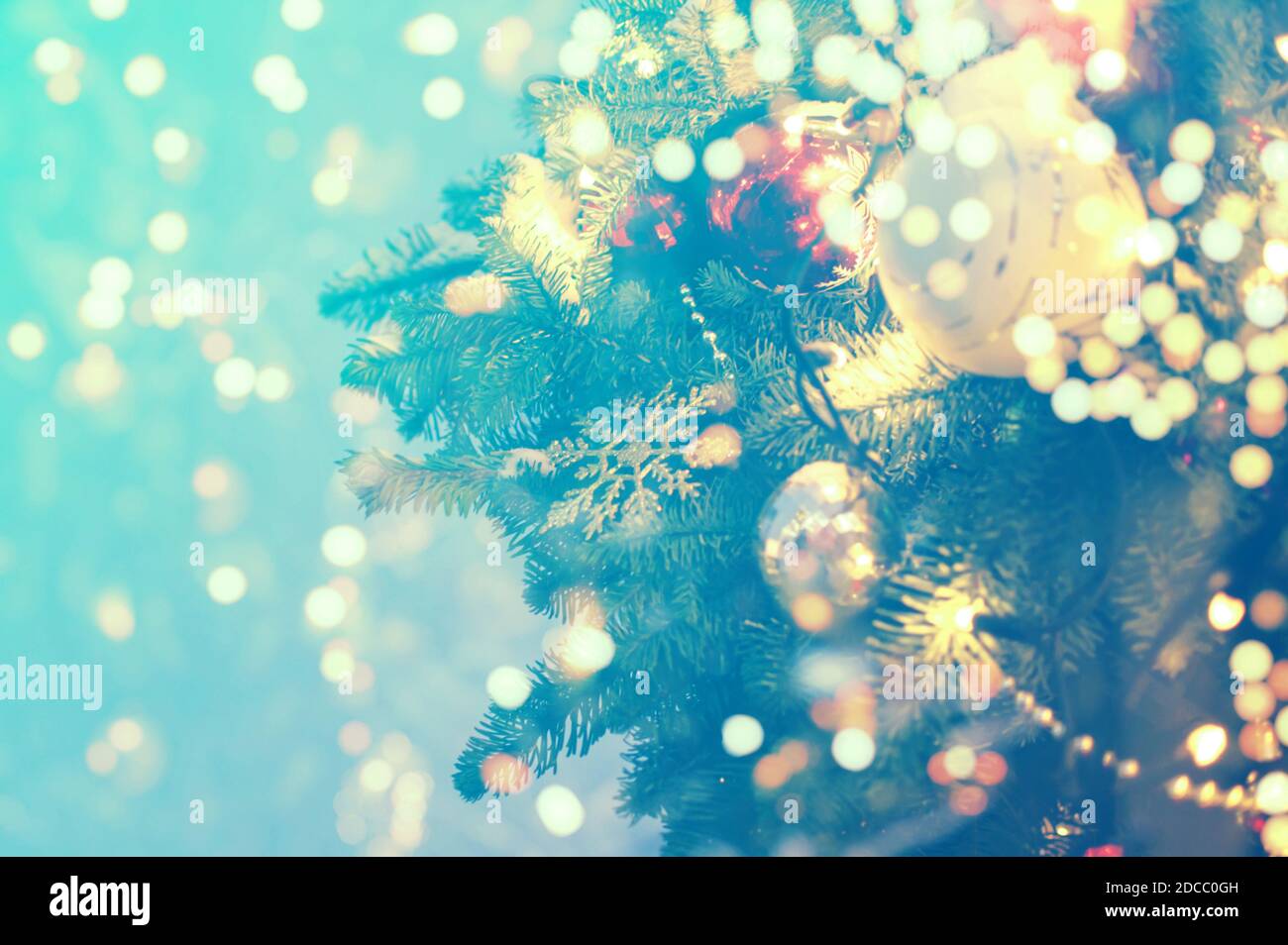 Christmas tree branch with christmas balls and lights, soft focus ...