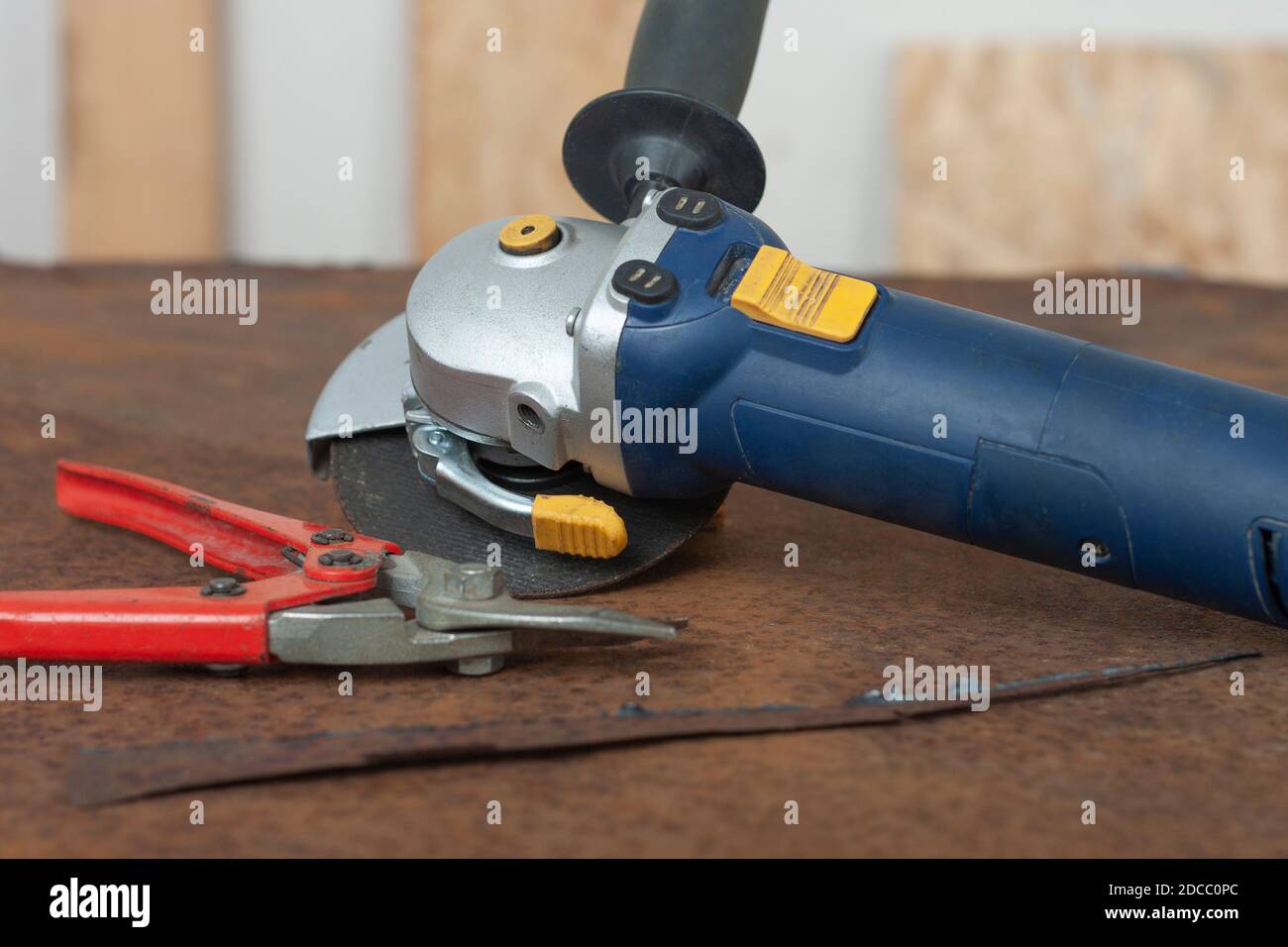 Angle grinder with thinner cut-off disc and red shears for cutting ...