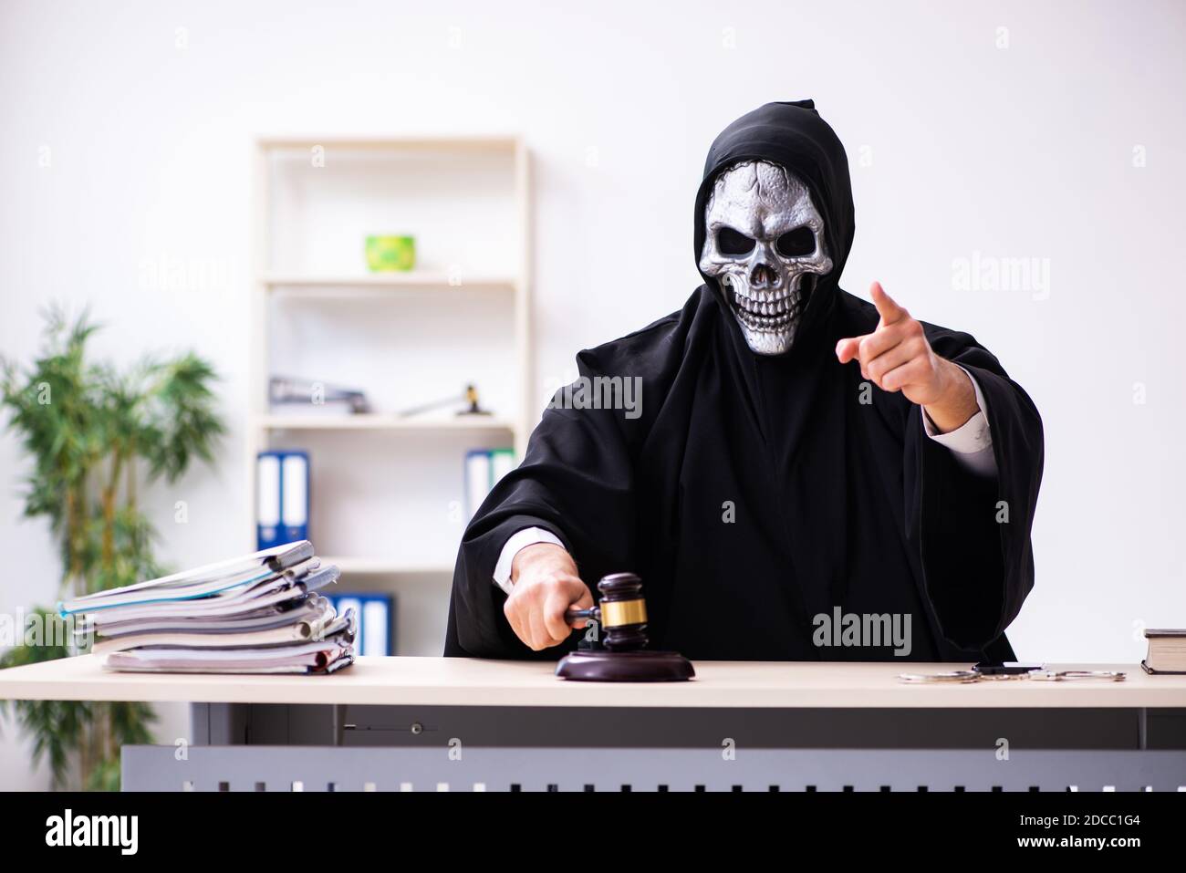 Devil judge working in the courthouse Stock Photo - Alamy