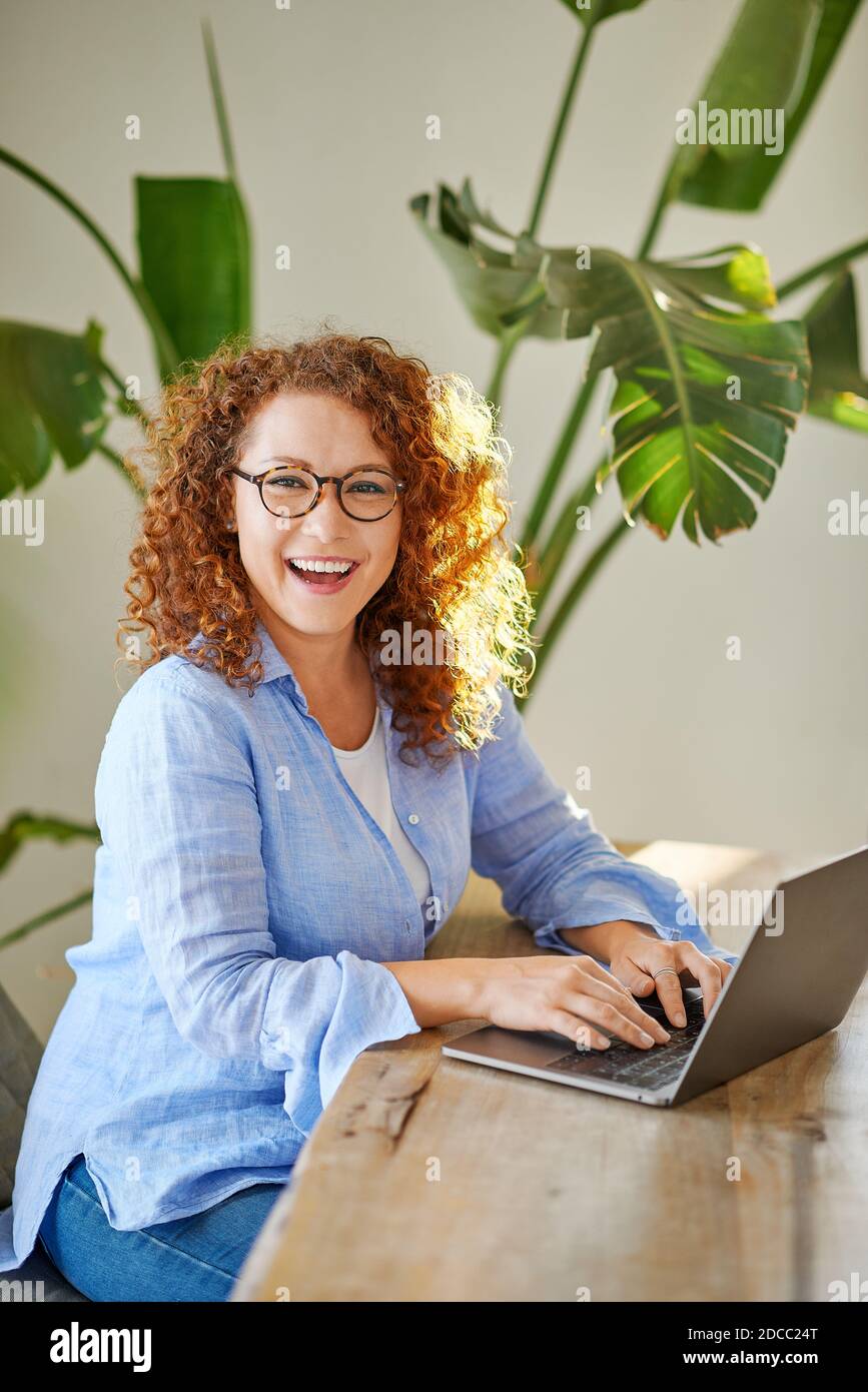 Red hair Female Studying On Laptop Stock Photo - Alamy
